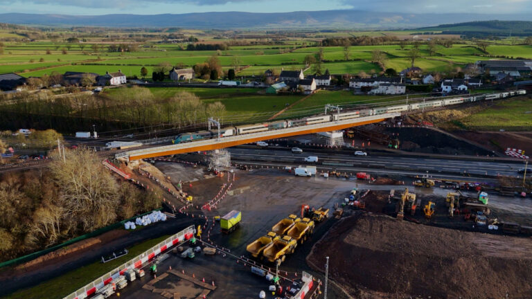 First trains run across new £60 million bridge as West Coast Main Line ...